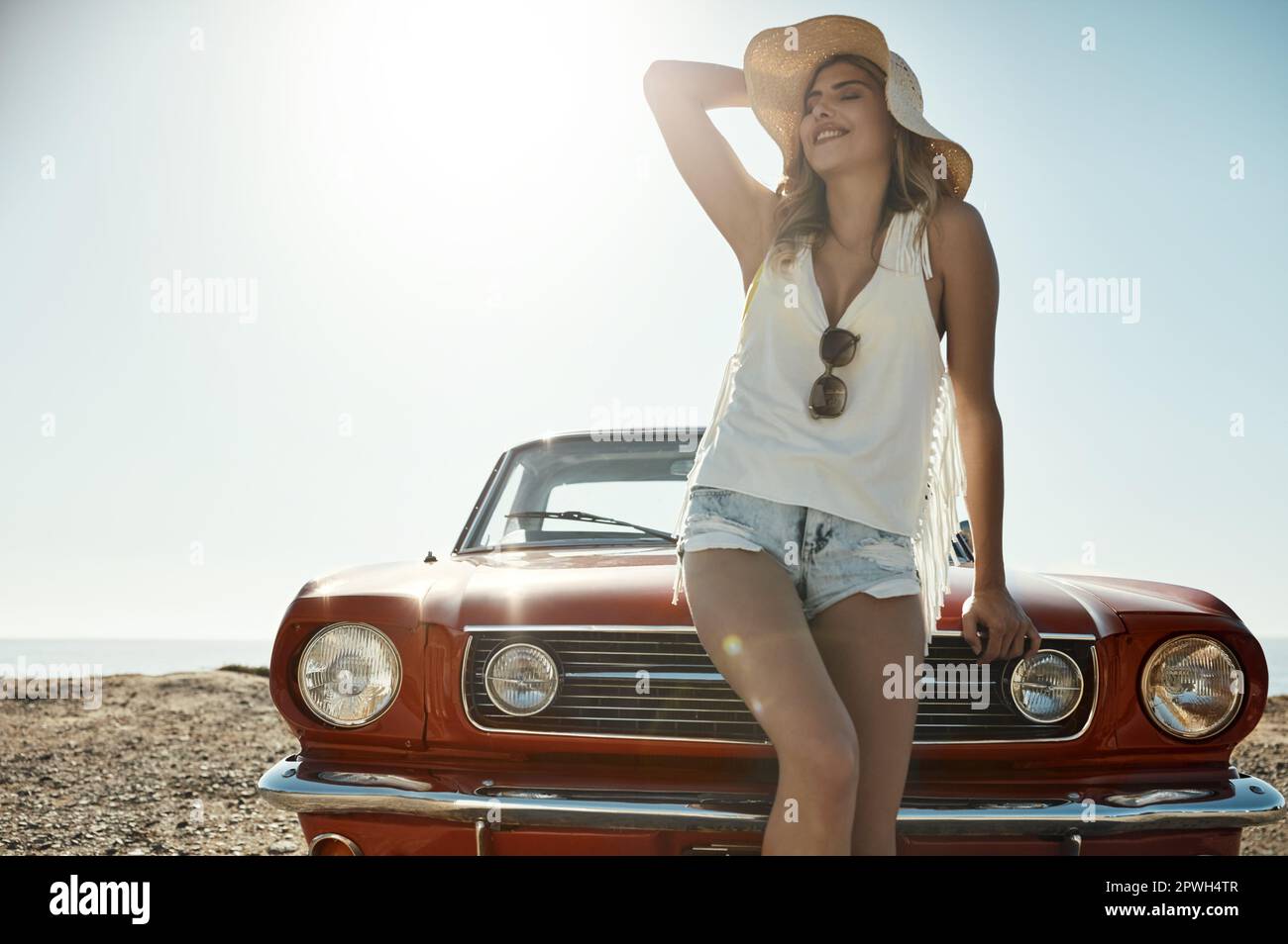 Road tripping is the ultimate freedom. an attractive young woman on a ...