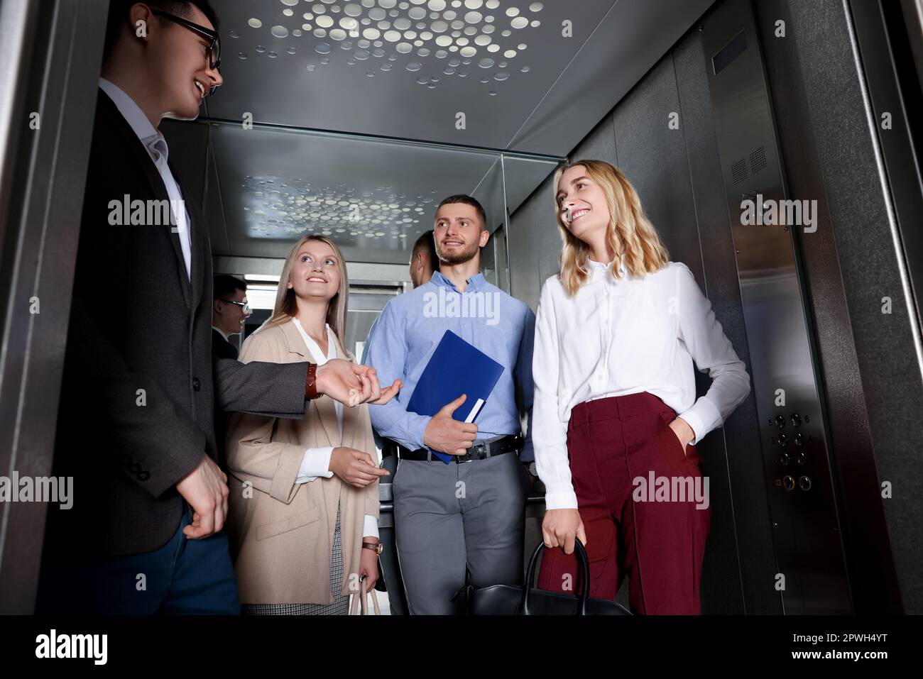 Inside elevator talking hi-res stock photography and images - Alamy