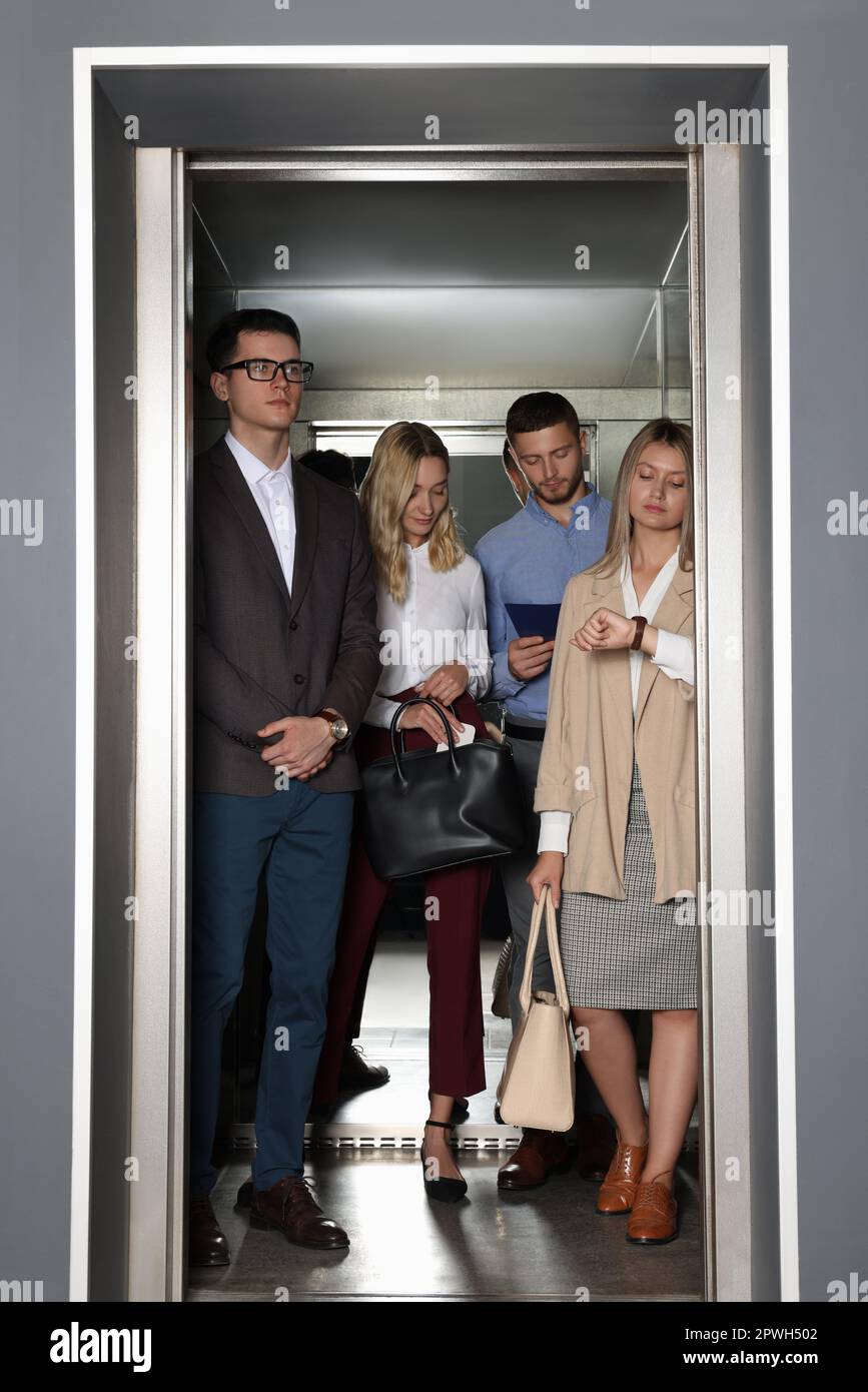 Group of office workers in modern elevator Stock Photo - Alamy