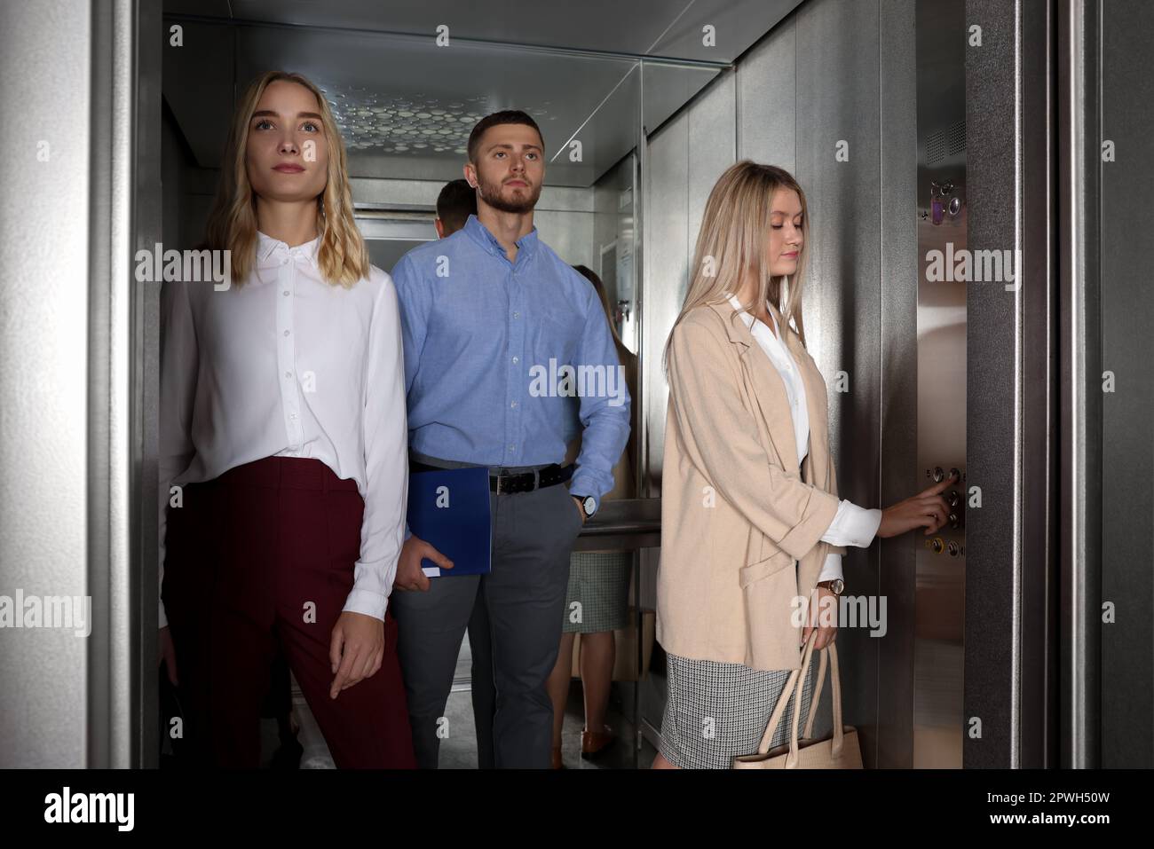Group of office workers in modern elevator Stock Photo - Alamy