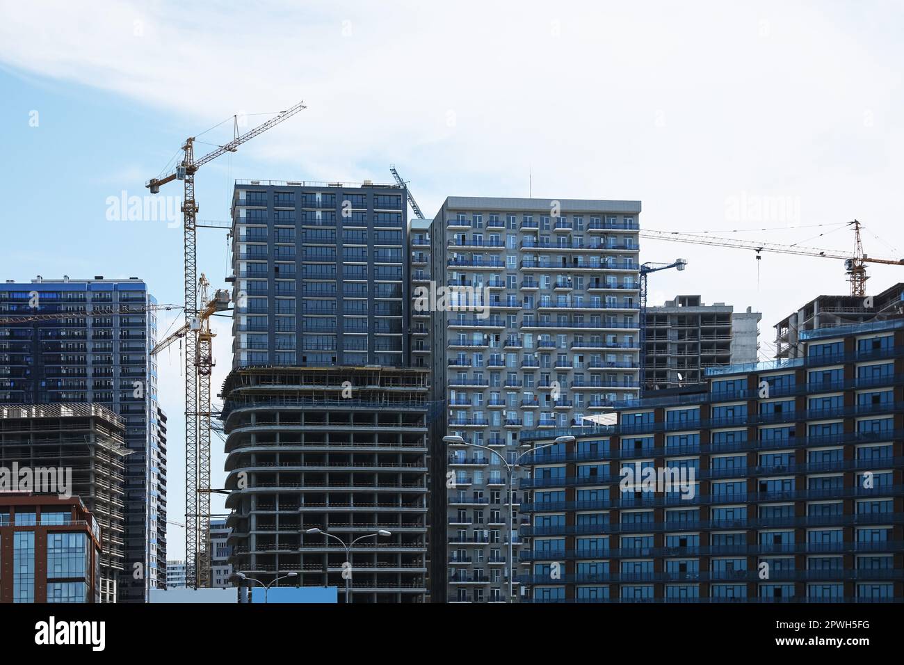 Construction site with tower cranes near unfinished buildings Stock ...