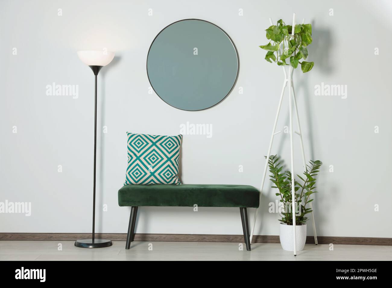Stylish round mirror on white wall over bench in room Stock Photo - Alamy