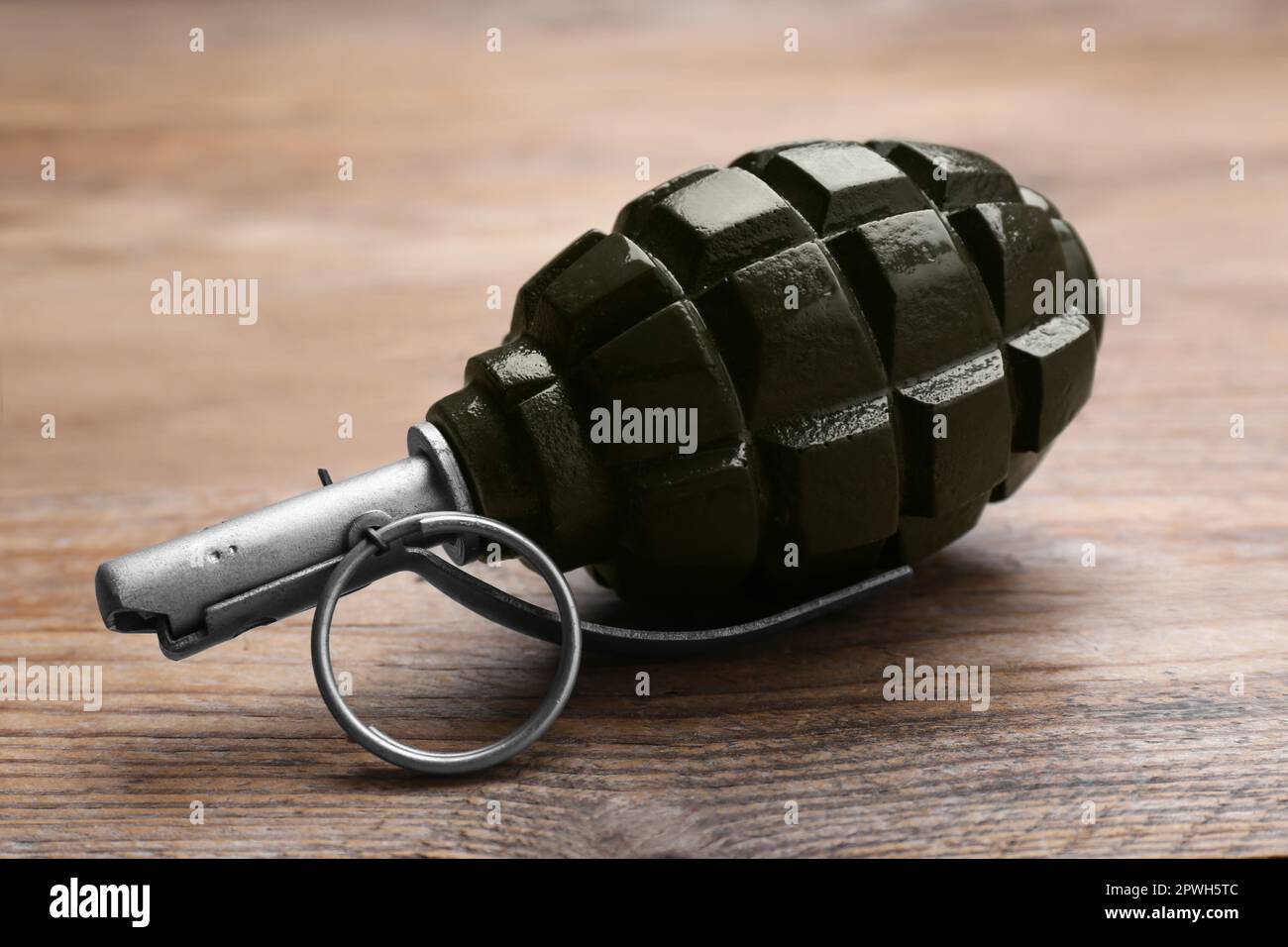 Hand grenade on wooden table, closeup. Explosive weapon Stock Photo - Alamy