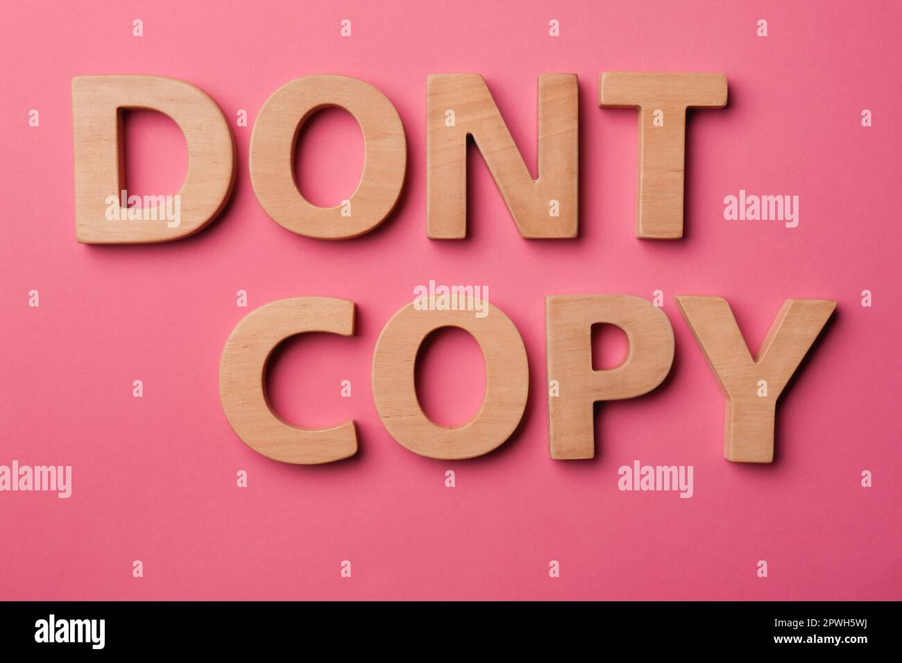 Words Don't Copy made of wooden letters on dark pink background, flat ...