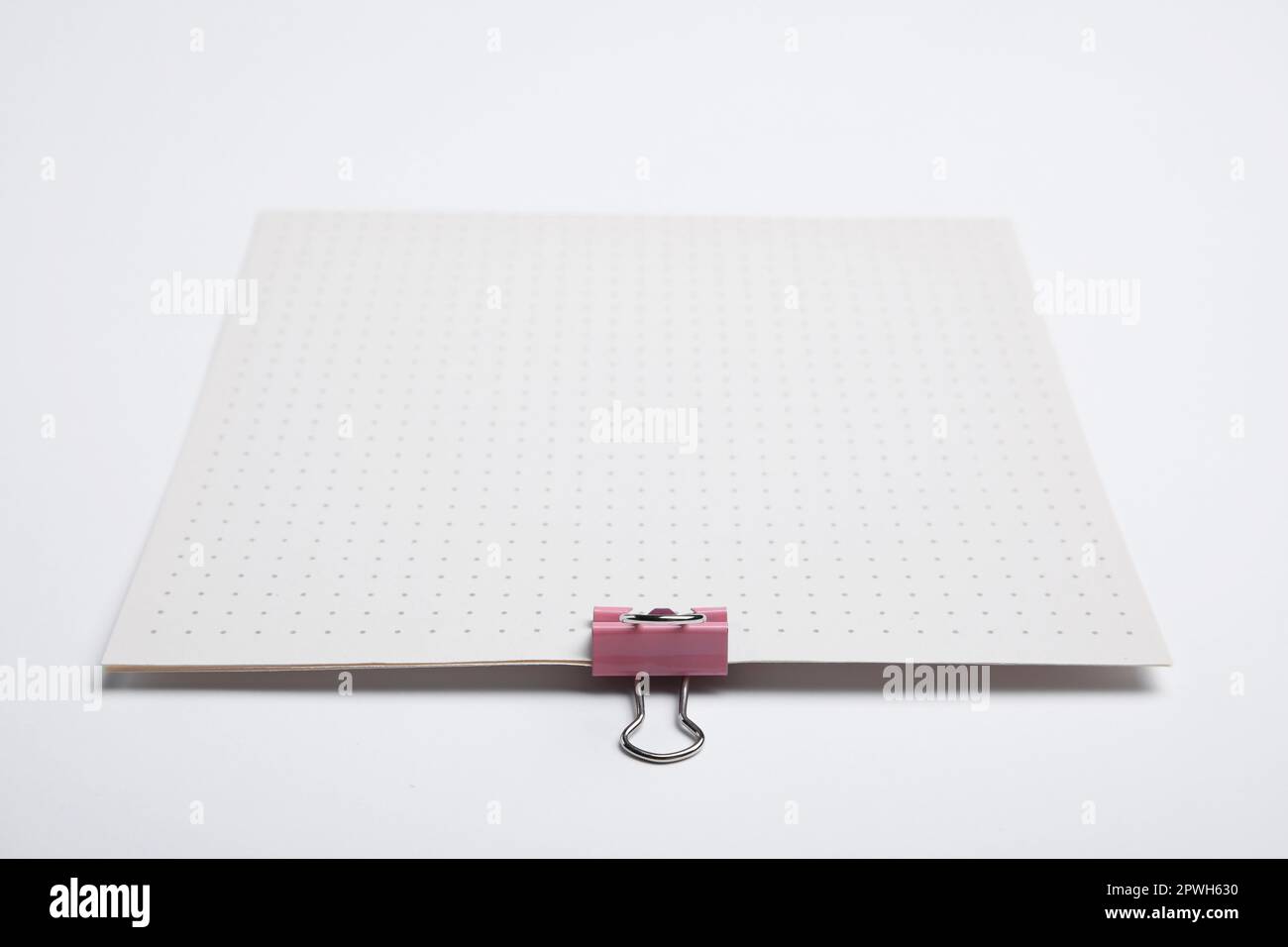 Sheets of paper with clip on white background Stock Photo - Alamy