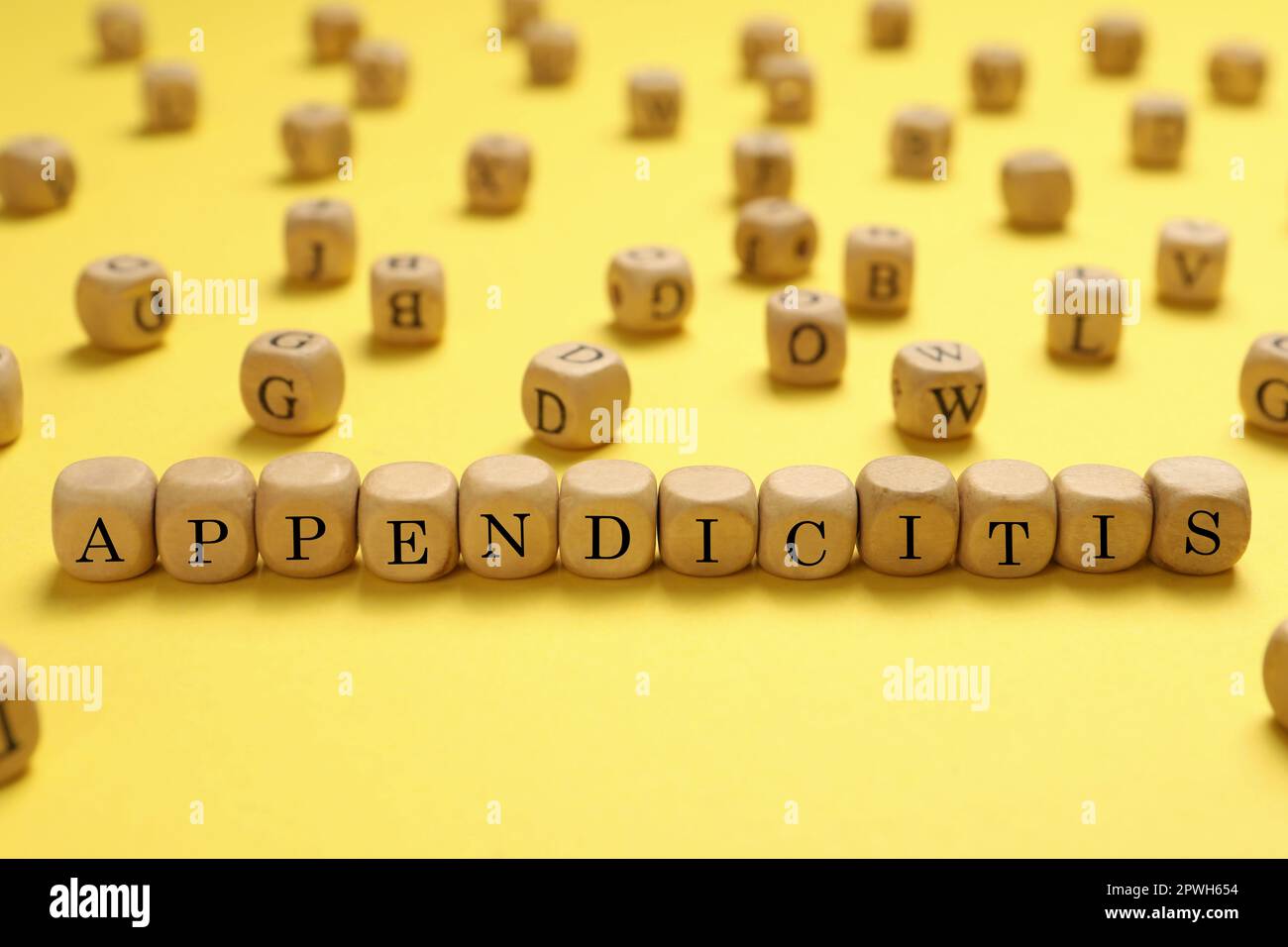 Word Appendicitis made of wooden cubes with letters on yellow ...