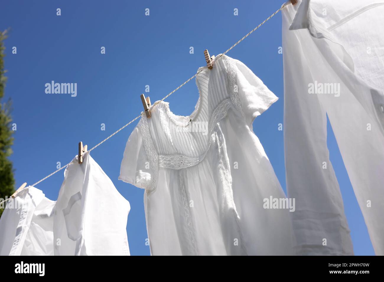 Clean clothes hanging on washing line against sky, low angle view ...