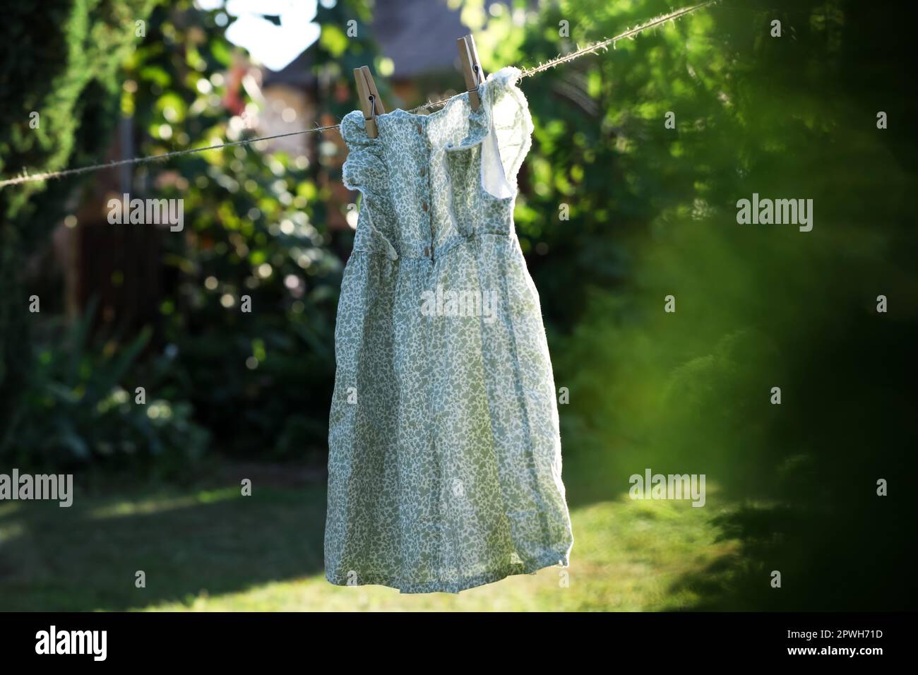 Dress drying on washing line near trees outdoors Stock Photo - Alamy
