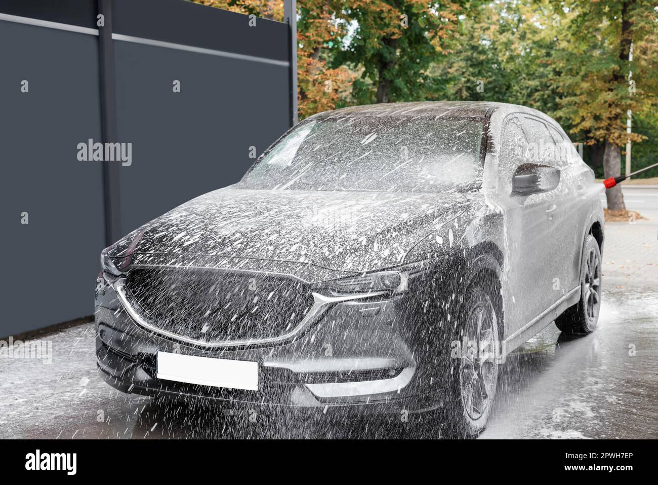 Washing auto with high pressure water jet at outdoor car wash Stock ...