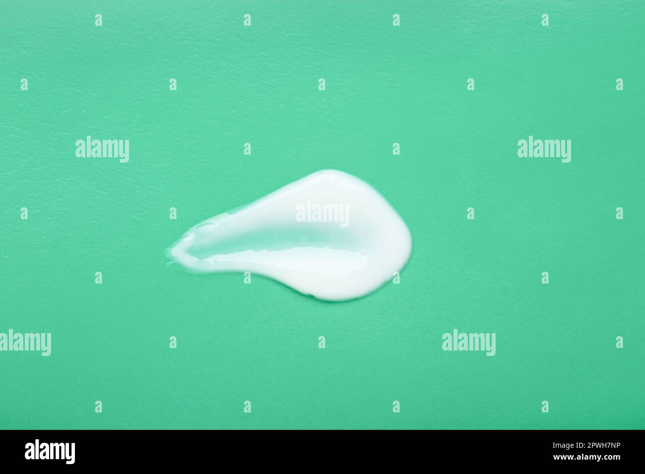Body cream sample on light green background, top view. Cosmetic product ...
