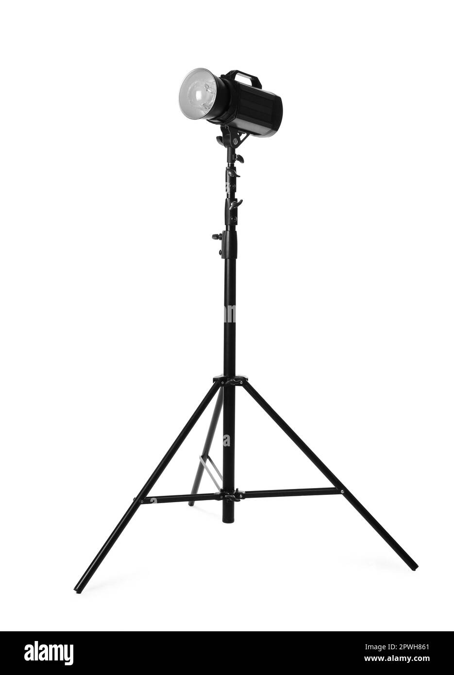 Studio flash light on tripod against white background. Professional ...