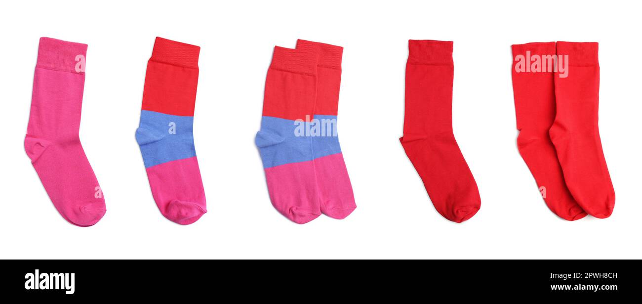 Set with pairs of different color socks on white background, top view ...