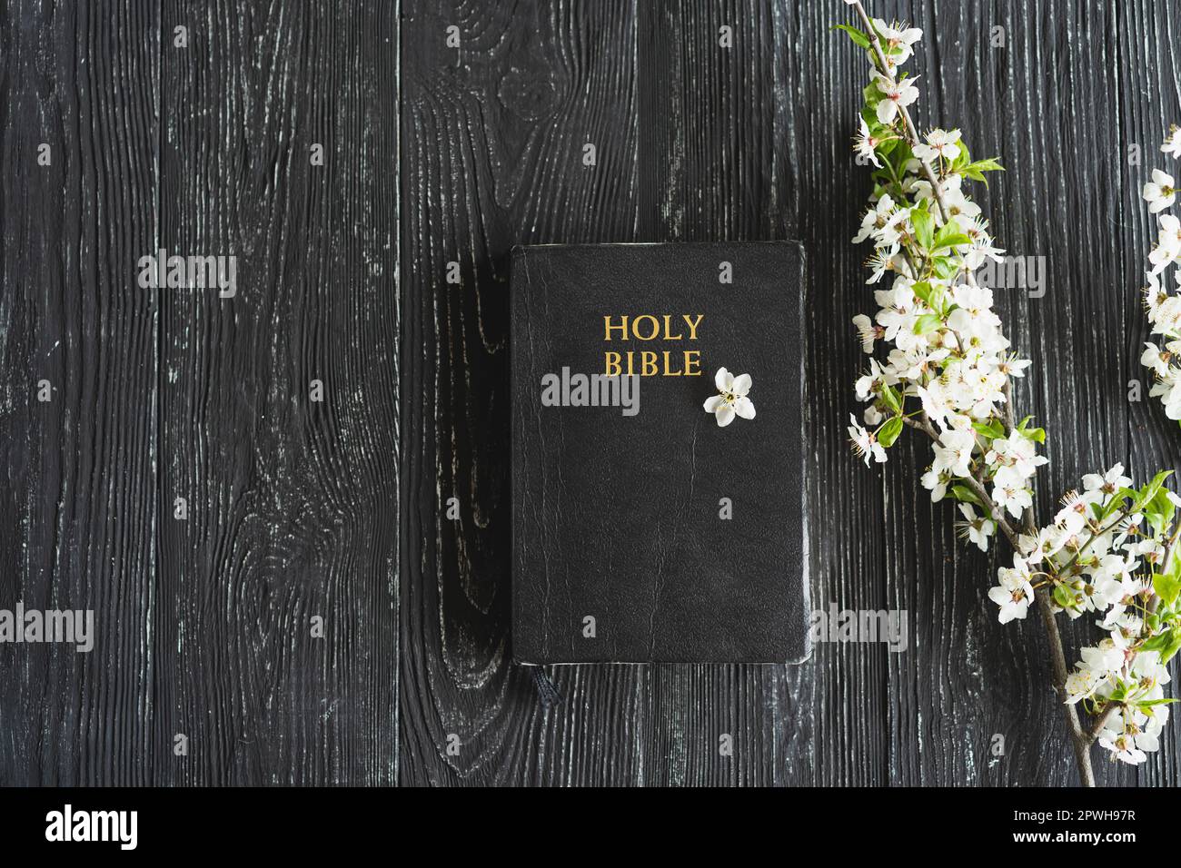 The Bible with spring flowers on a wooden background. Concept for faith ...