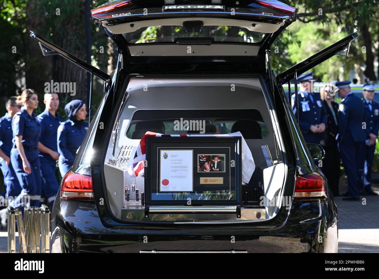 The casket of paramedic Steven Tougher arrives in a hearse to his ...