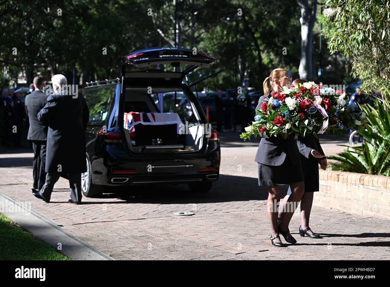 The casket of paramedic Steven Tougher arrives in a hearse to his ...