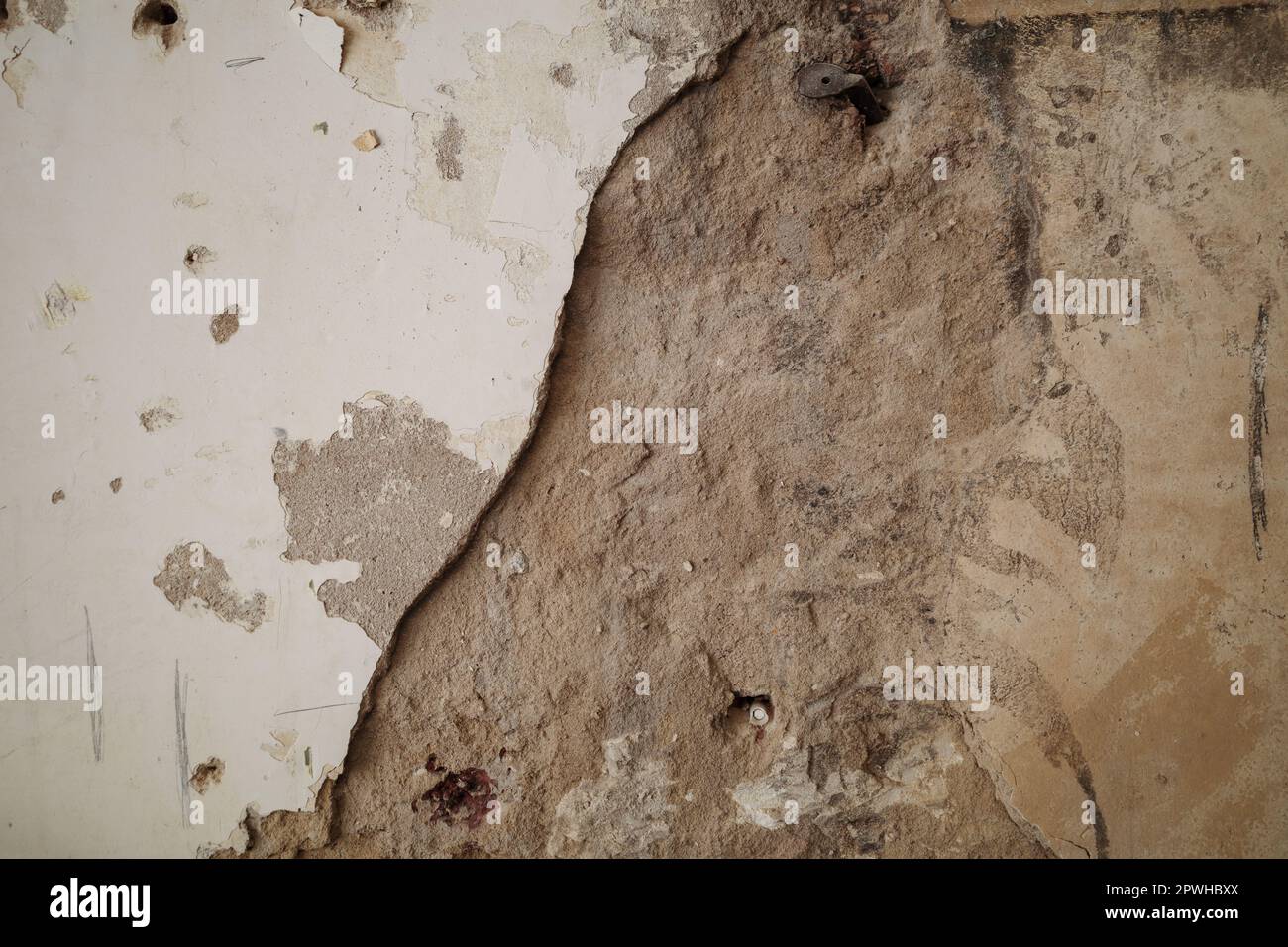 Rough concrete structural wall with scar of cracking plaster and stucco ...