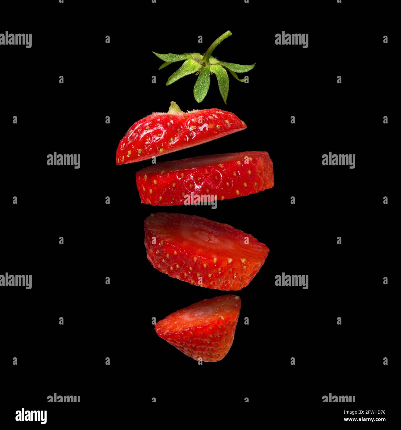 Strawberry slices isolated on black background. Surreal design. Pieces ...