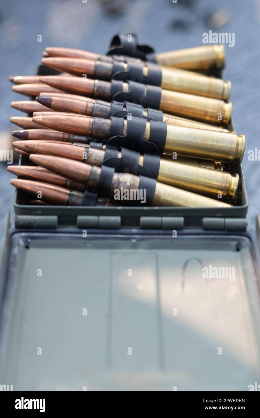 An ammo can filled with .50-caliber machine gun rounds sits on the deck ...