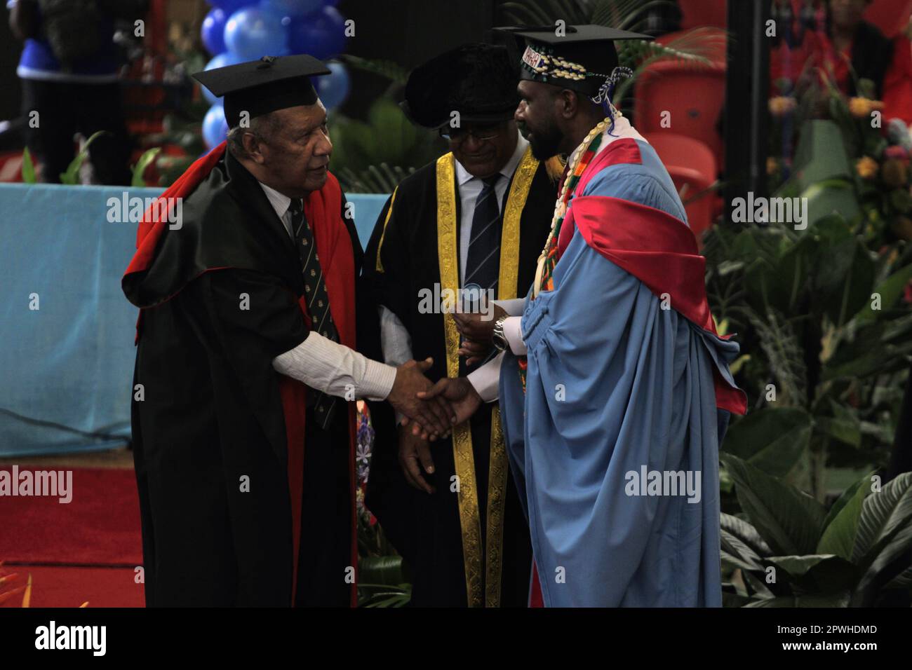 A female graduate receiving her diploma from the UPNG Vice Chancellor ...