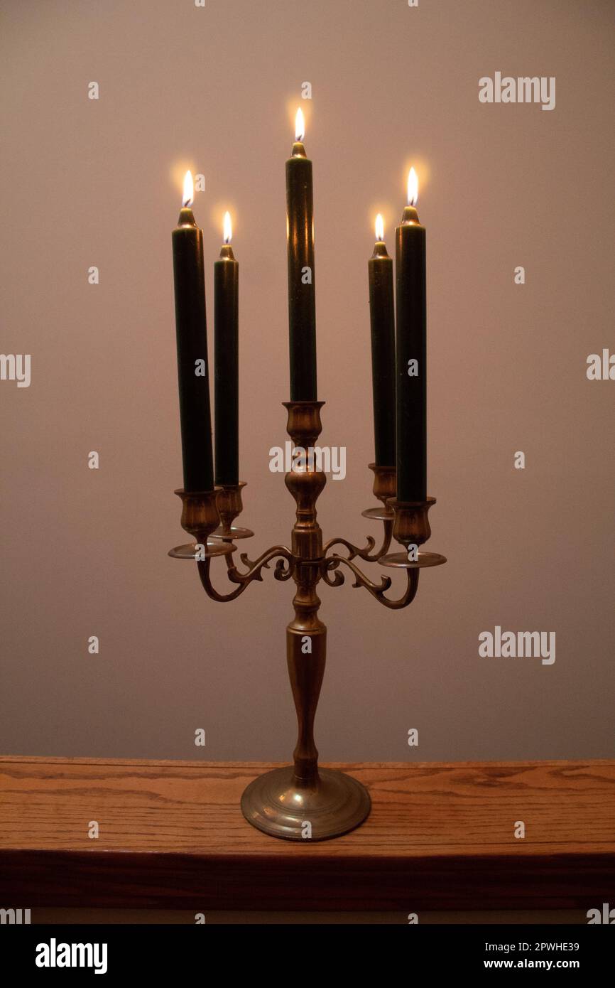 Lit candles in a candelabra Stock Photo - Alamy