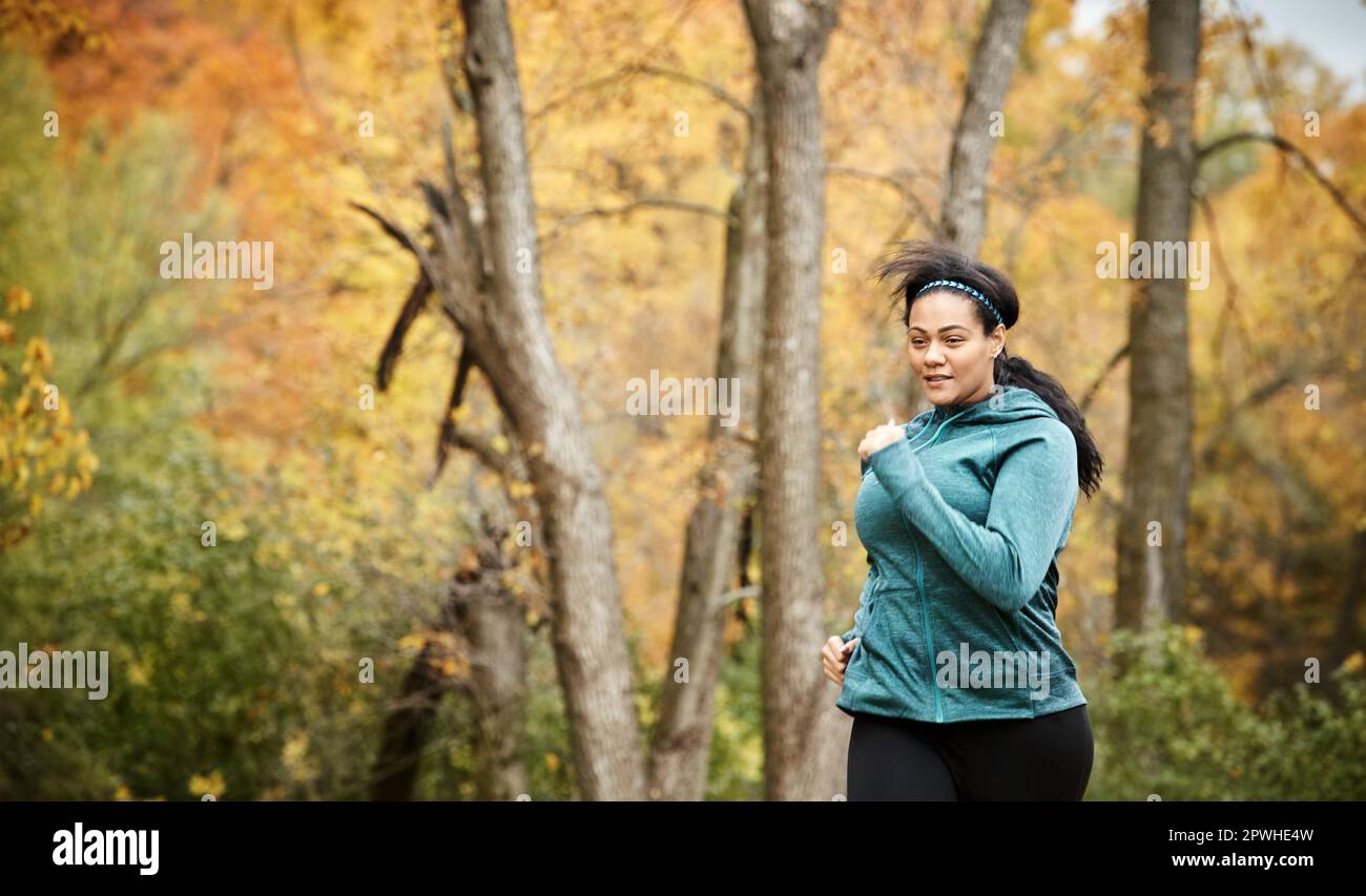 Get going and dont stop. an attractive young woman going for a run in ...