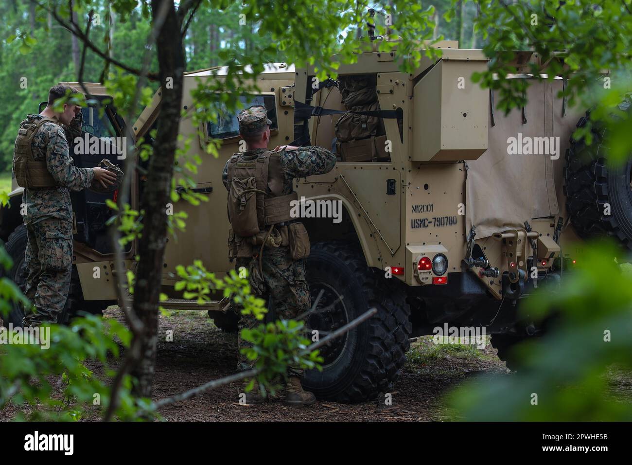 U.S. Marines with Headquarters Battalion (HQ Bn), 2d Marine Division prepare to move a vehicle ...