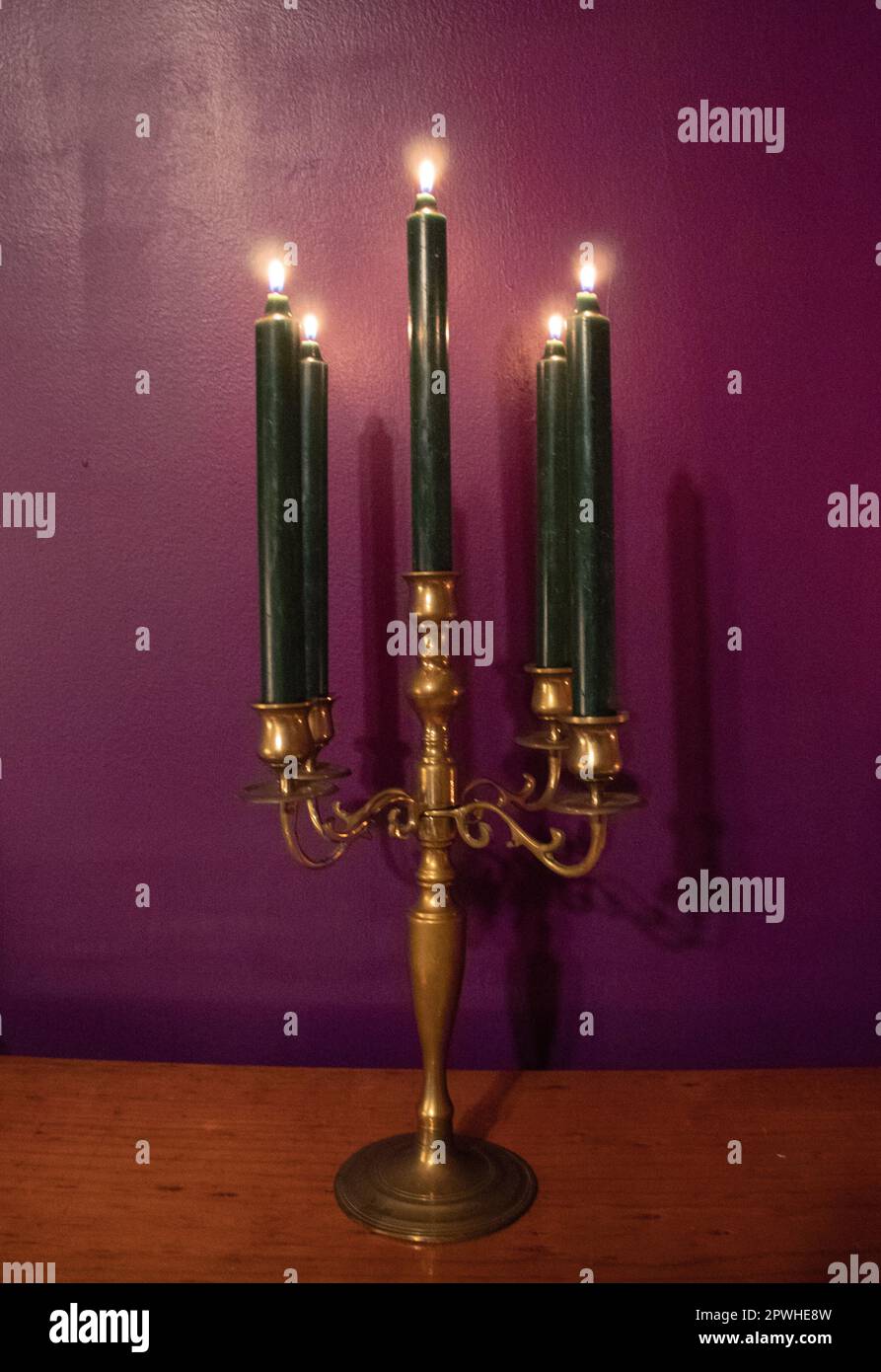 Lit candles in a candelabra Stock Photo - Alamy