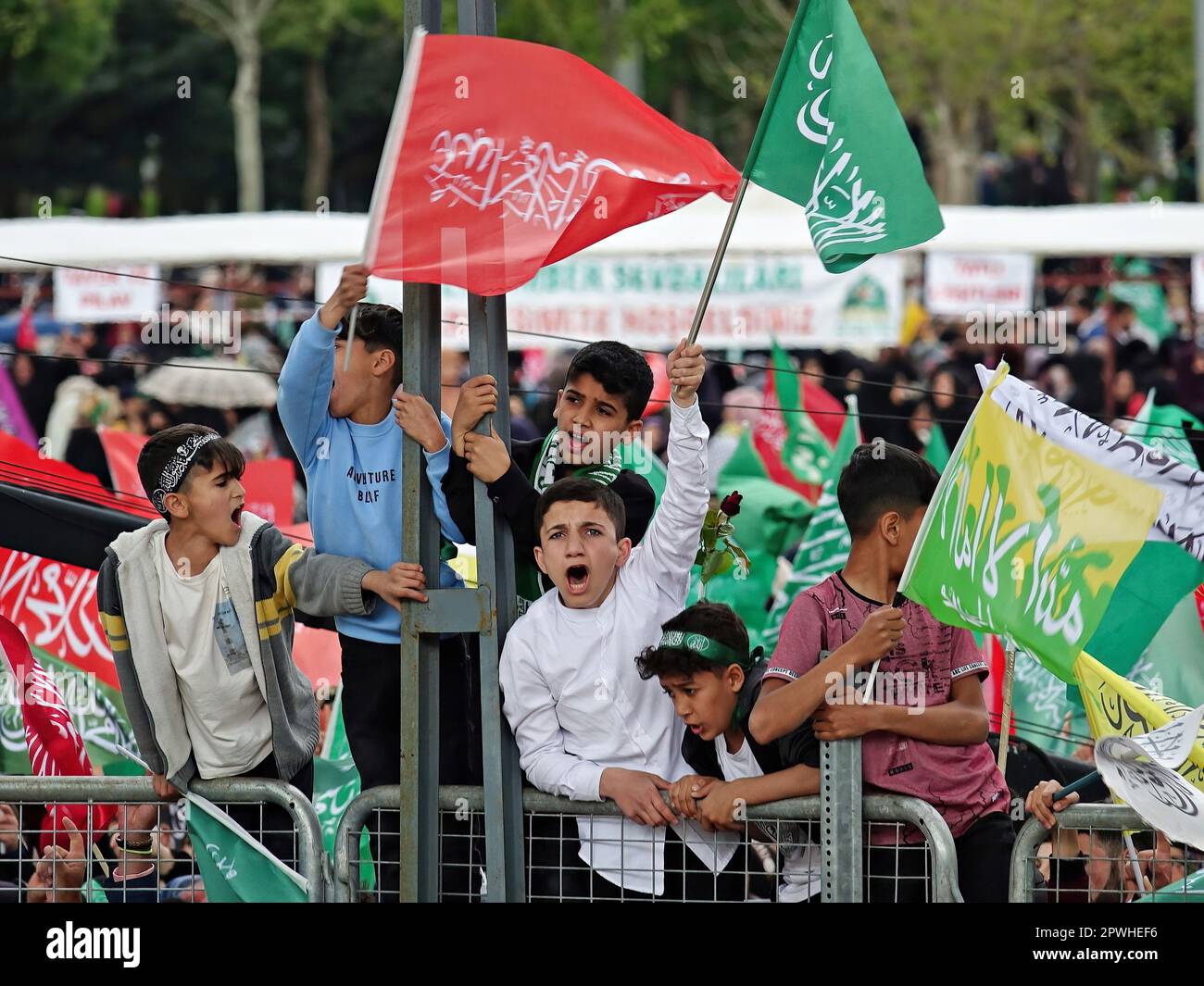 Children are seen waving flags during the birthday event of the Islamic ...