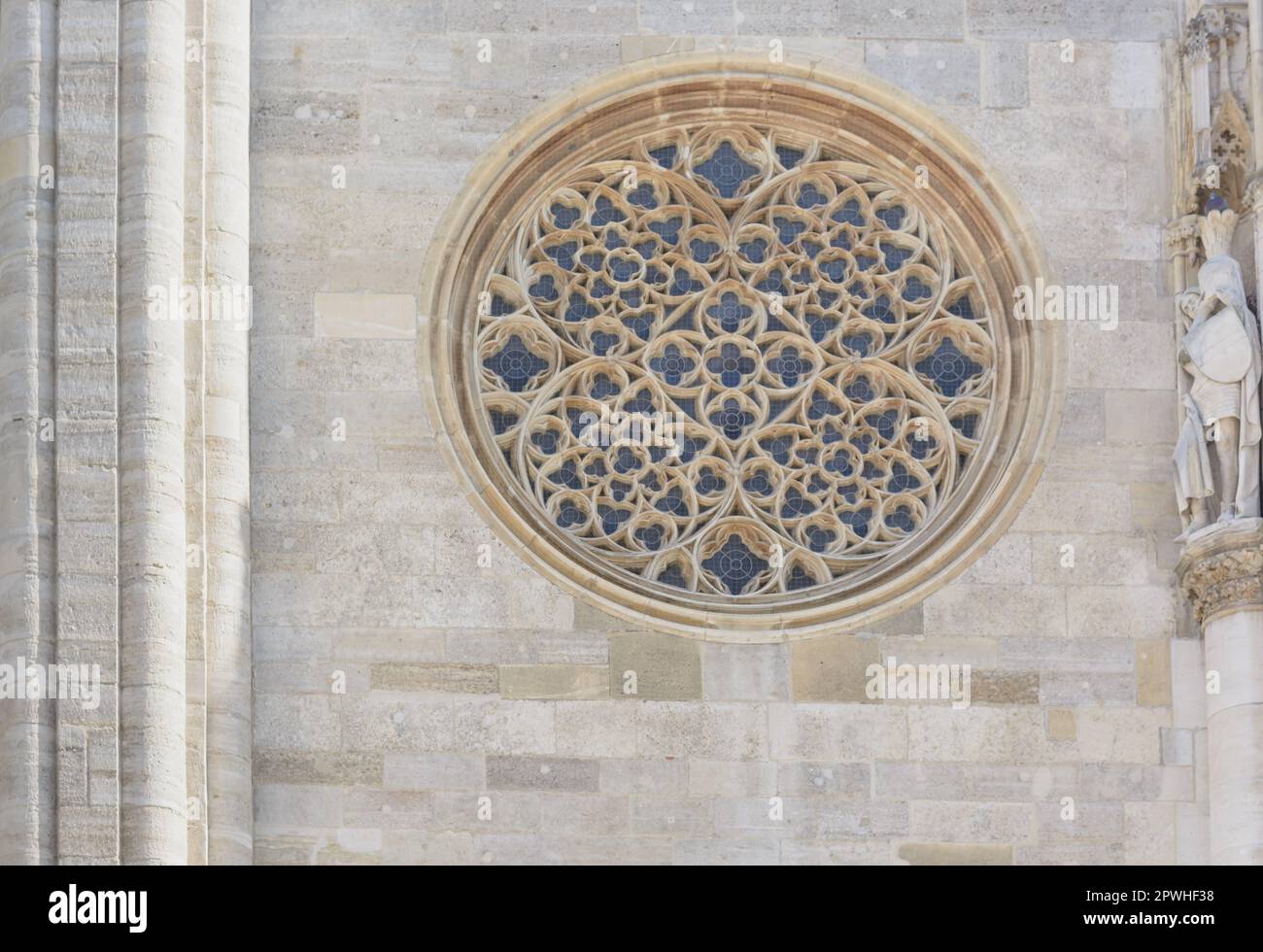 Gothic round window against the stone wall of St. Stephen's Cathedral ...