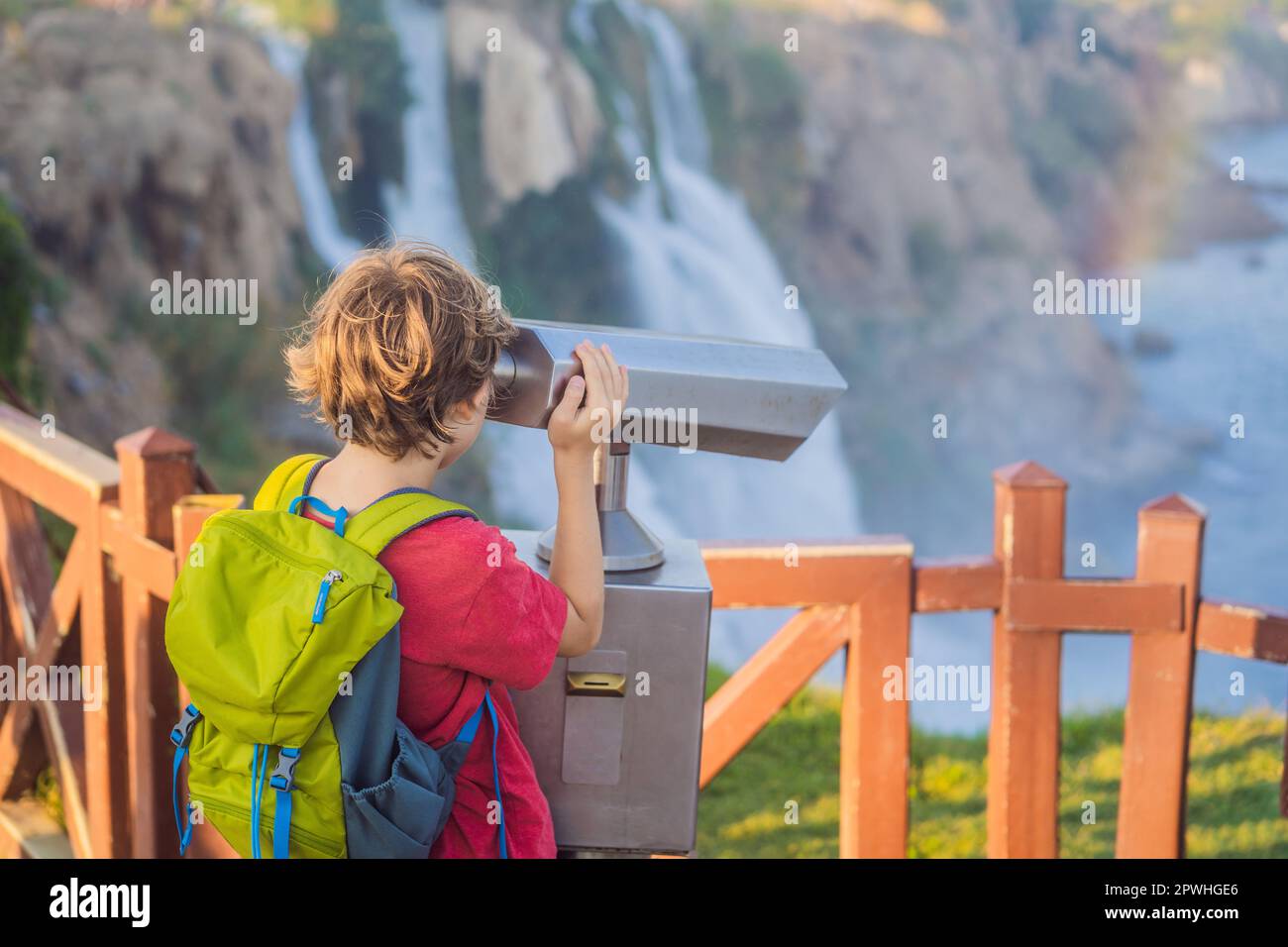 Boy tourist with a backpack on the background of Duden waterfall in ...