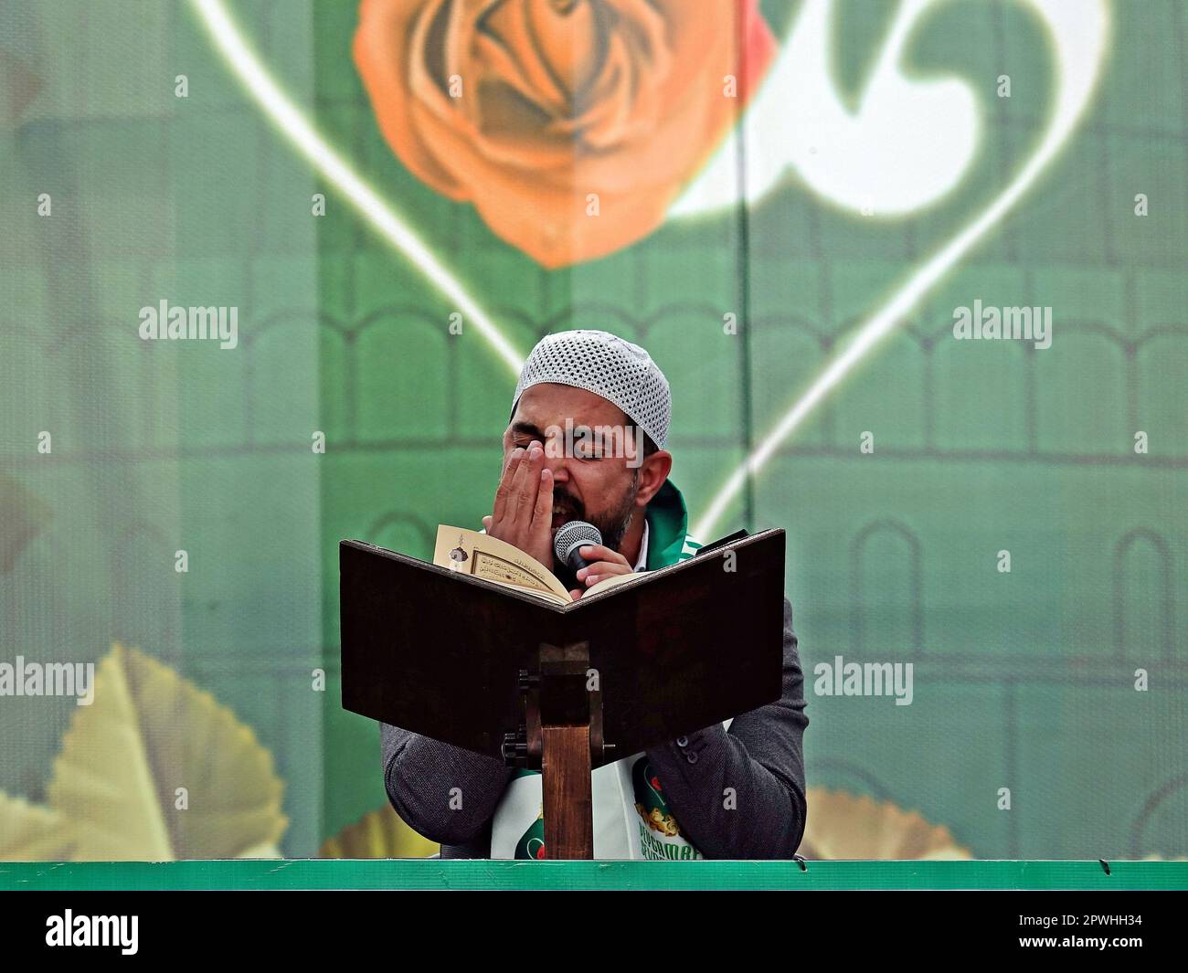 A hafiz seen reading the Holy Quran at the event. The birth of the ...