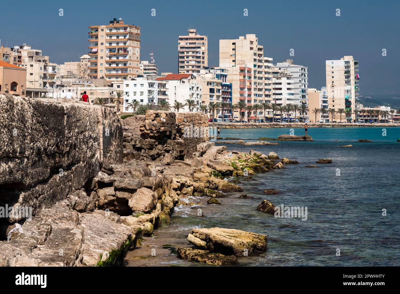 Phoenician city wall at ancient island area, and buildings on courseway ...