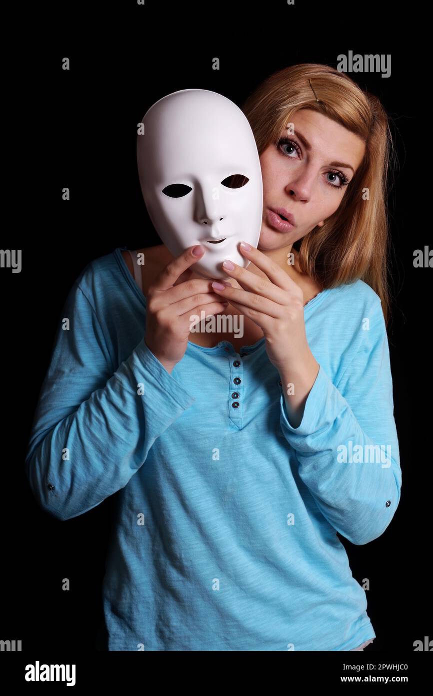 young woman removing plain white mask from her face Stock Photo - Alamy