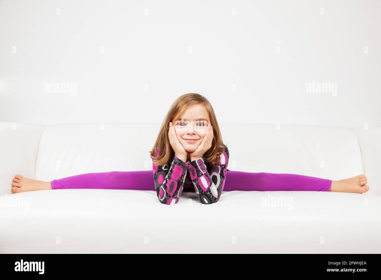 Cute little girl making splits Stock Photo - Alamy