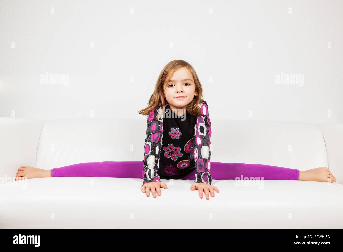 Cute little girl making splits Stock Photo - Alamy