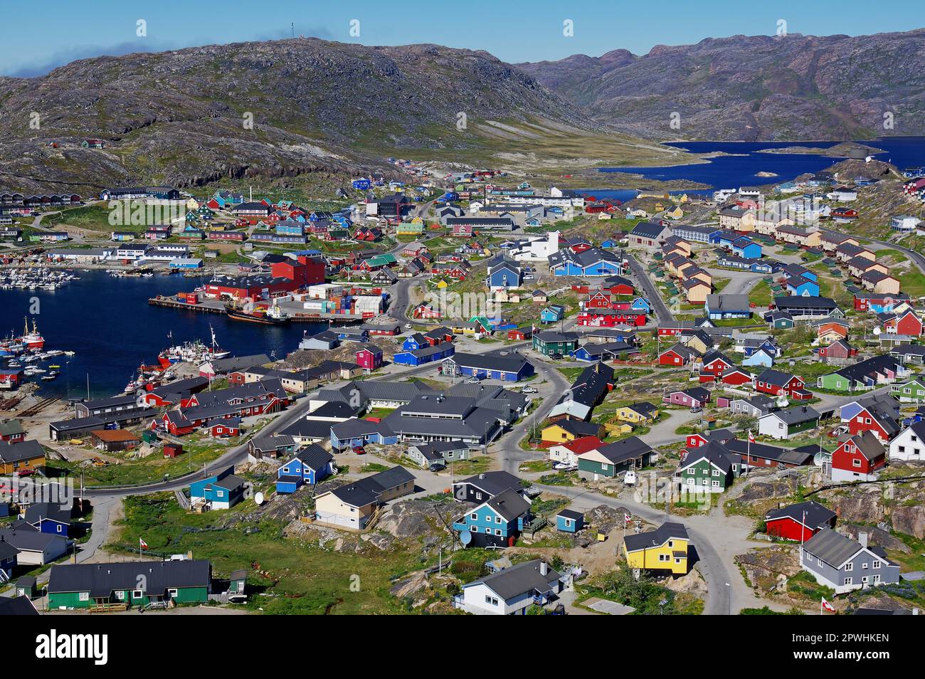 View over a small town, football pitch, rugged mountain landscape, Qaqortoq, Kujalleq ...