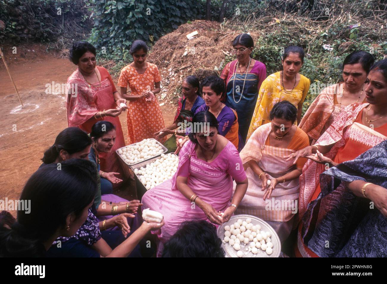 Kodava women making rice ball Kadamputtu during Huthri festival, Kodagu ...