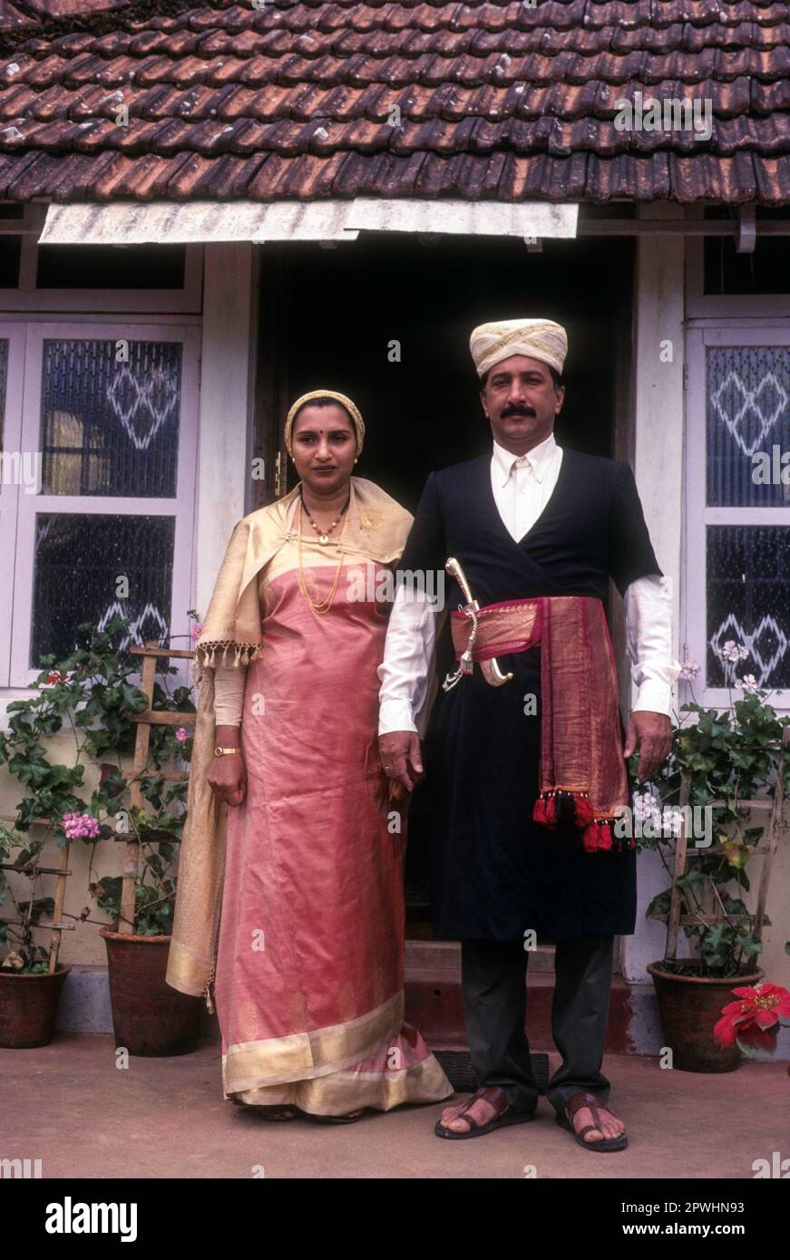 Kodava couple in traditional house in front of their house, Kodagu ...