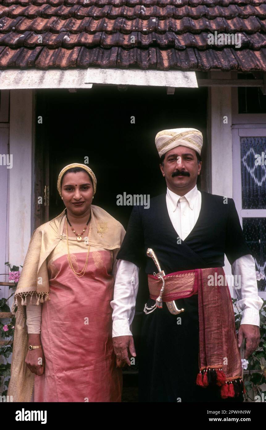 Kodava couple in traditional house in front of their house, Kodagu ...