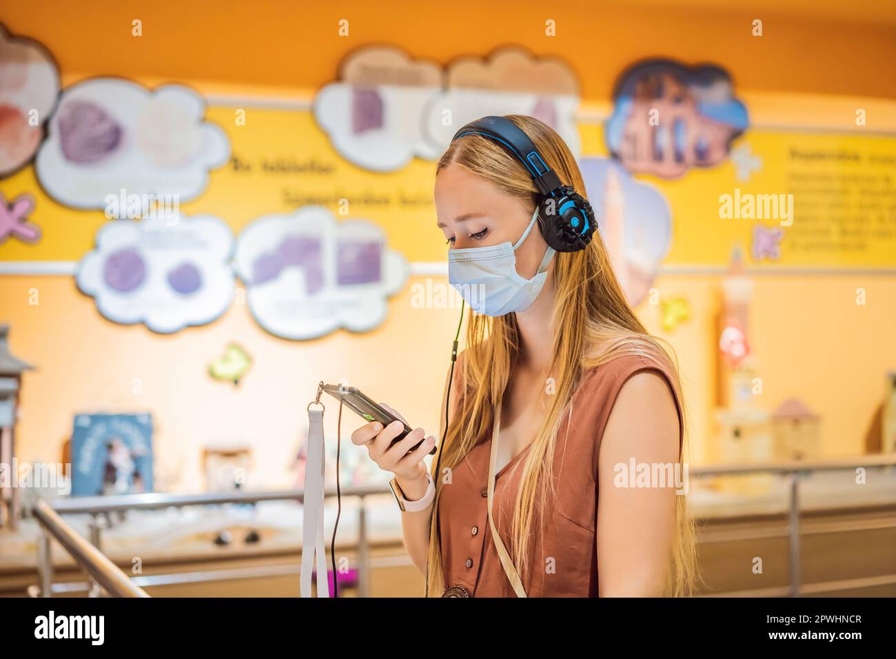 Portrait of contemporary young woman looking at sculptures and ...