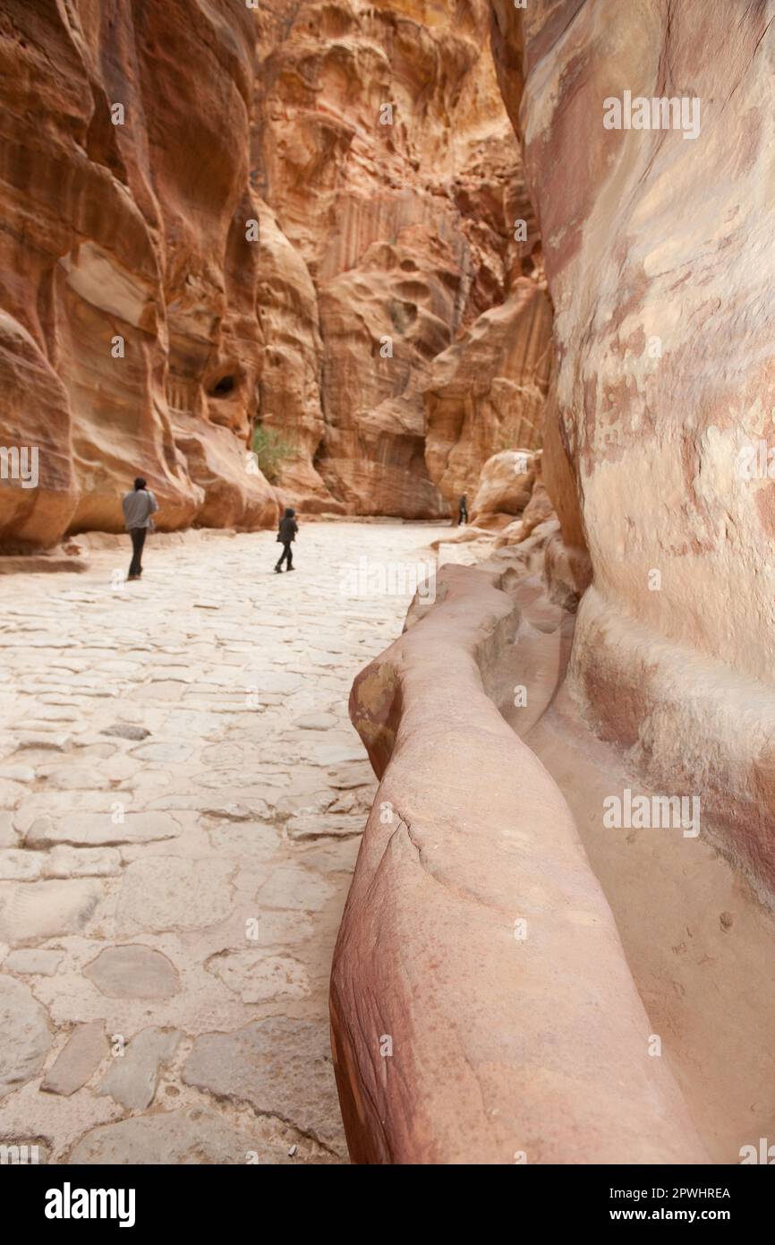 Ancient water conduit in Siq, canyon, gorge, ancient paving stones ...