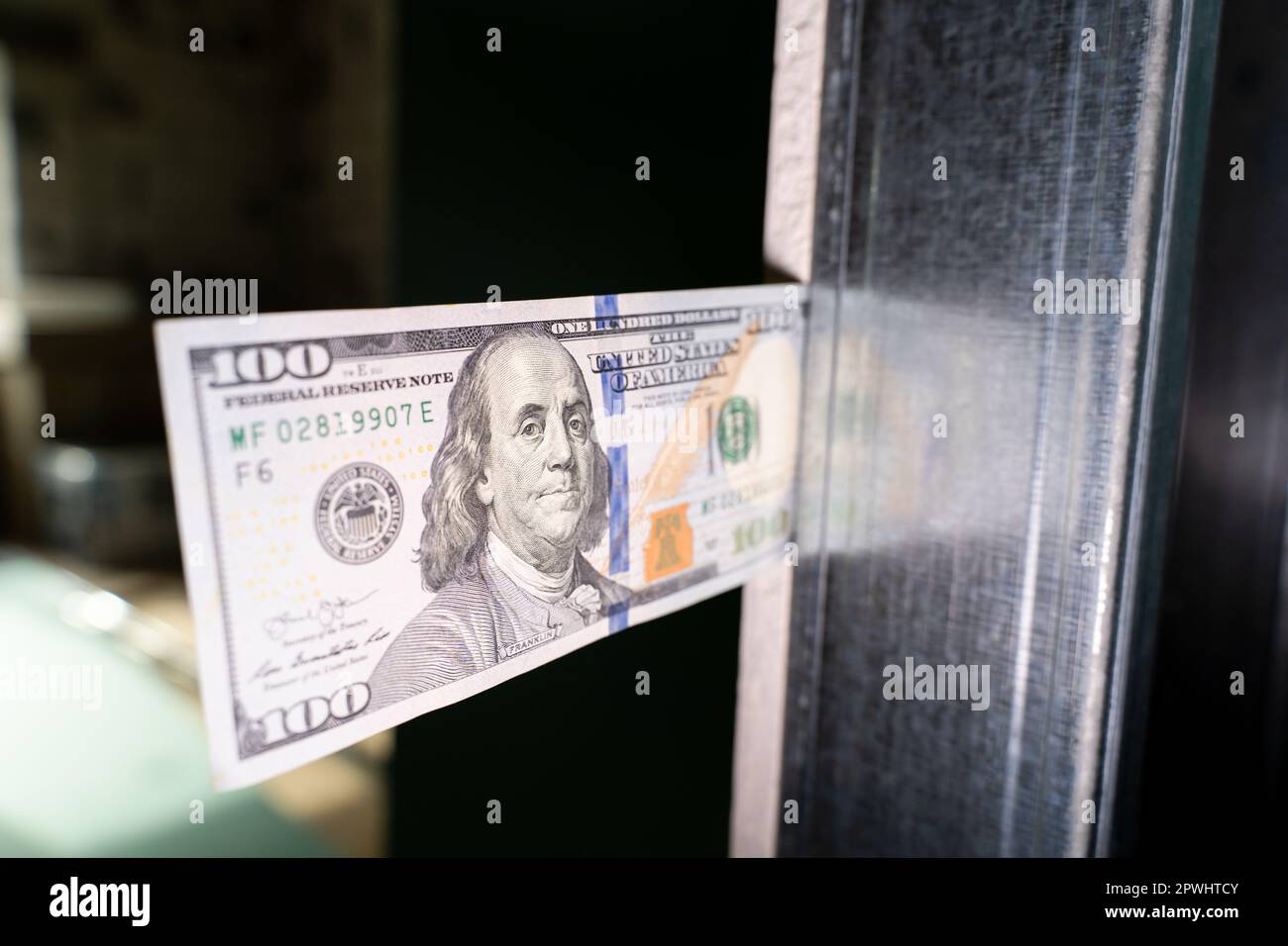 One hundred dollars in cash inserted into an unfinished plasterboard ...