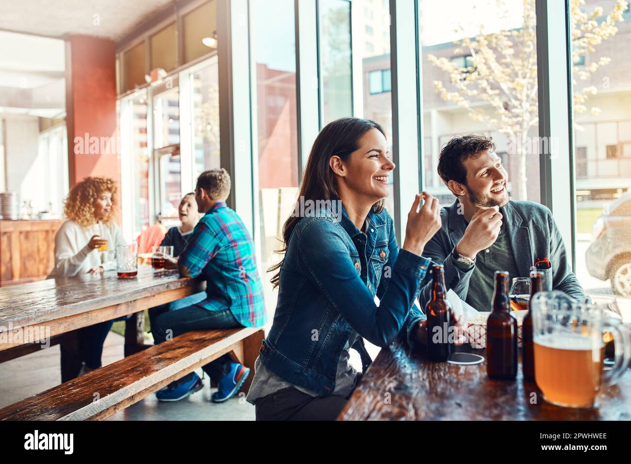 You can never go wrong with a beer bar date. a young couple having ...