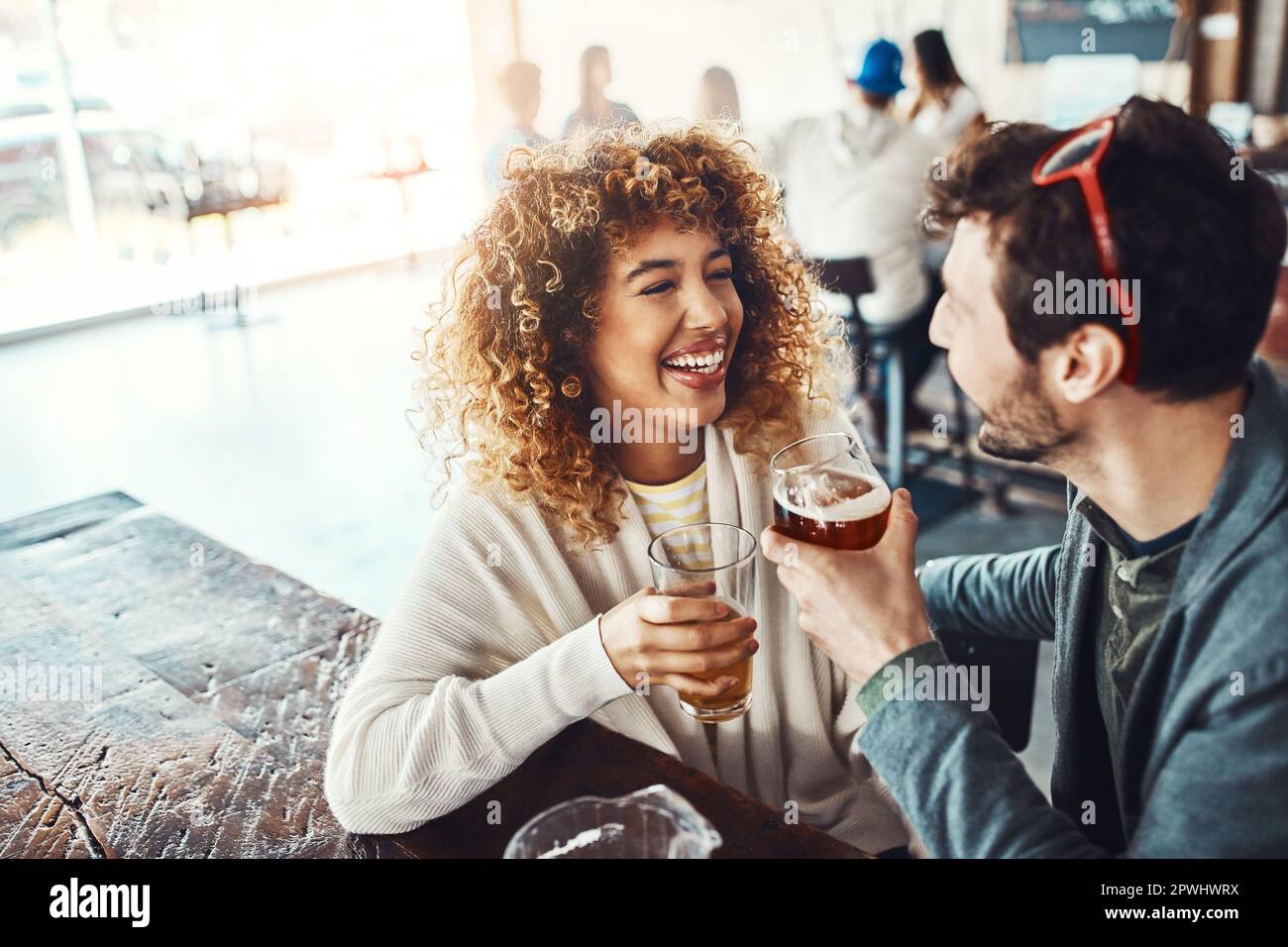 You tell the best stories. a happy young man and woman having beers at ...