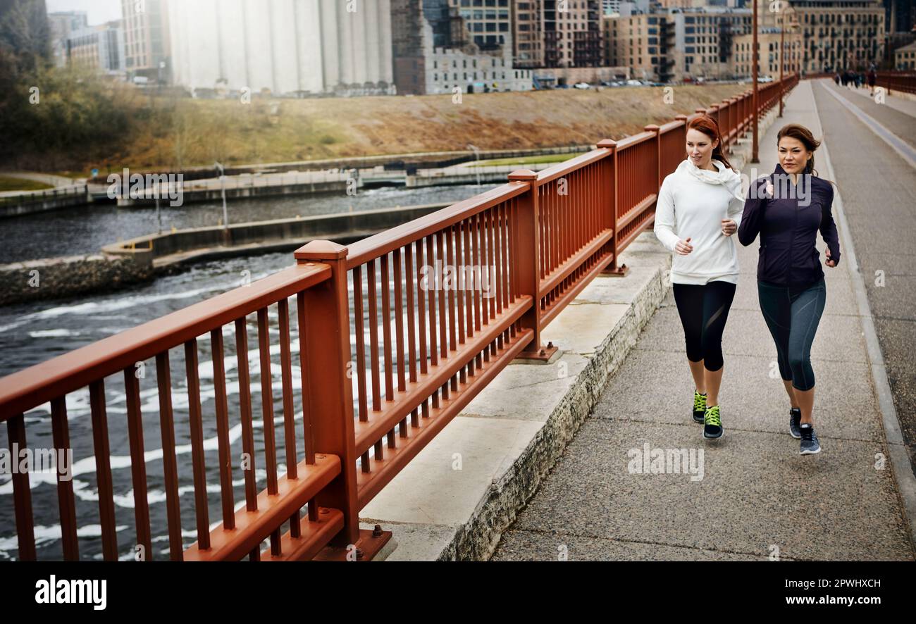 Running is better with a friend. Full length shot of two attractive ...