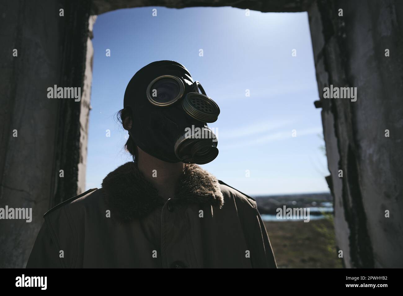 a person wearing a gas mask is standing in front of the window of a ...