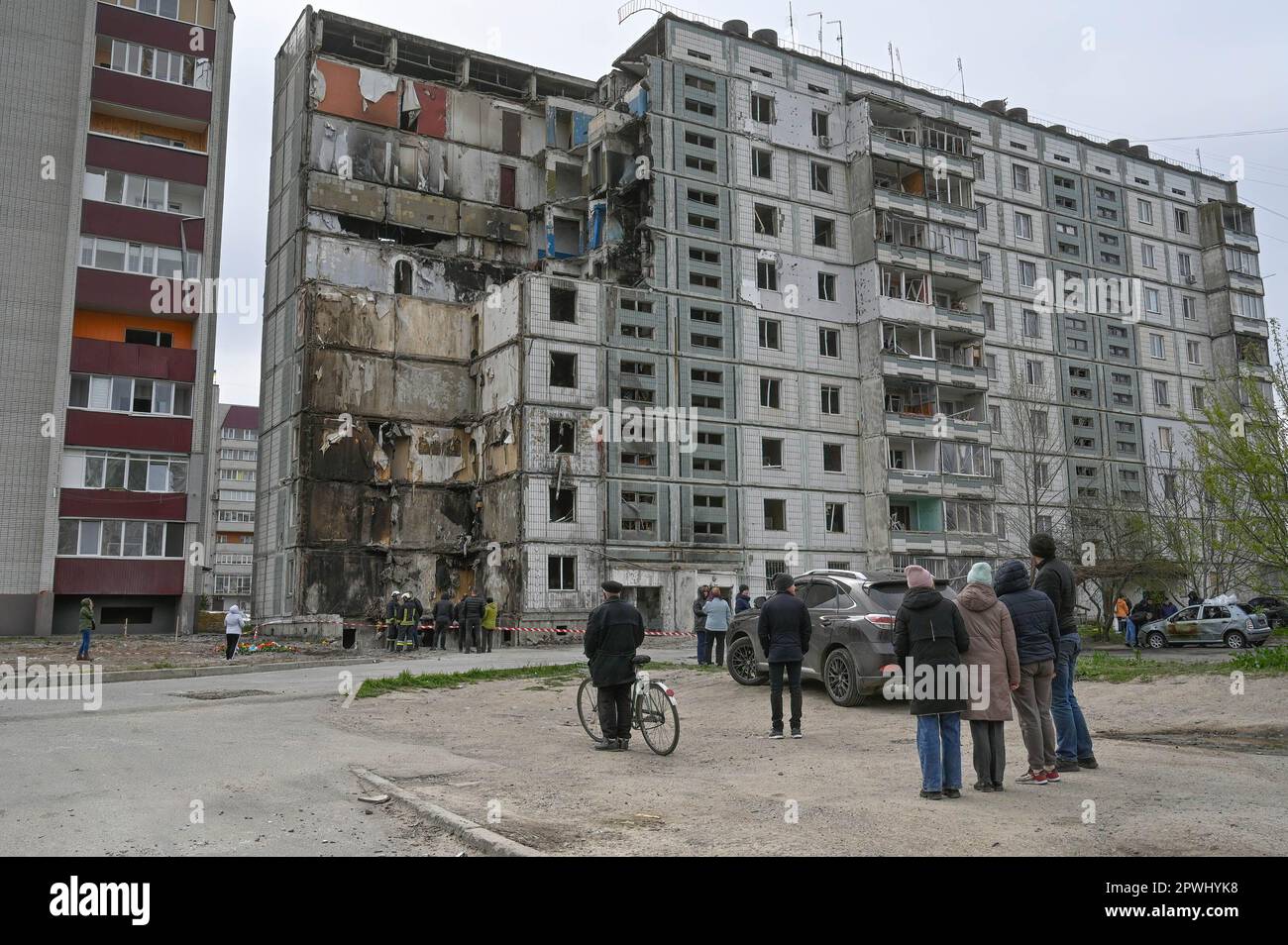 Uman, Ukraine. 30th Apr, 2023. People stand near destroyed house that ...