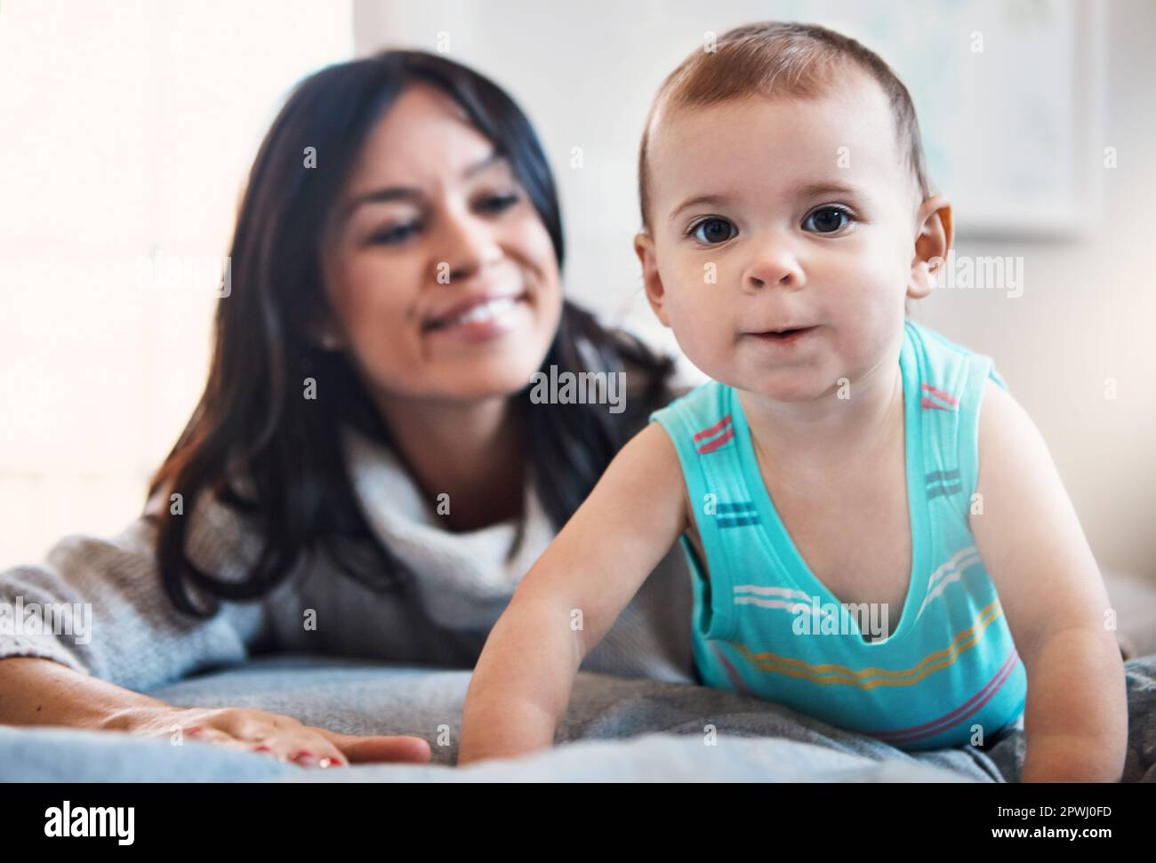 Watch out world, here I come. an adorable baby girl crawling on a bed ...