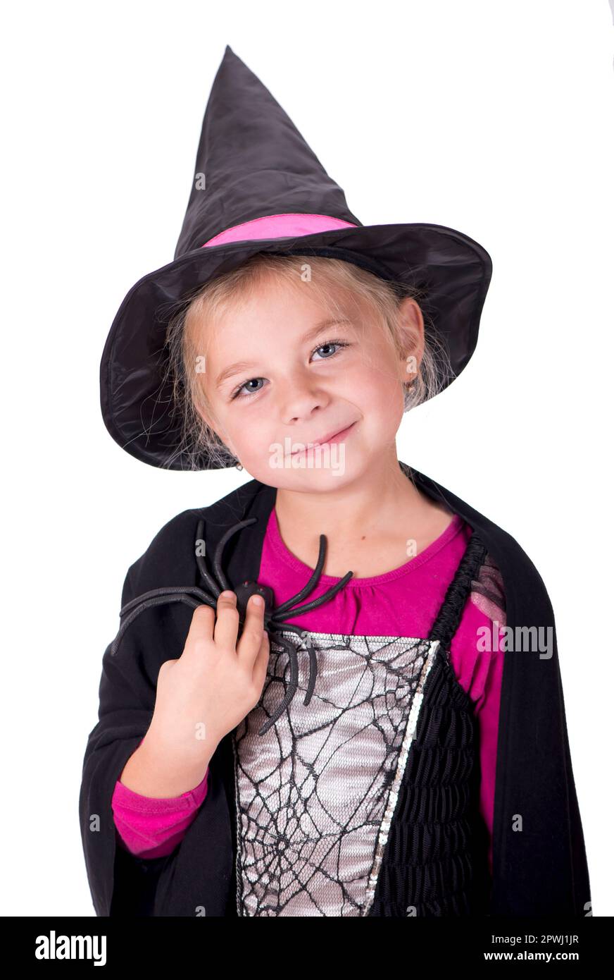 A beautiful girl in a witch costume, in a hat, with a spider in her ...