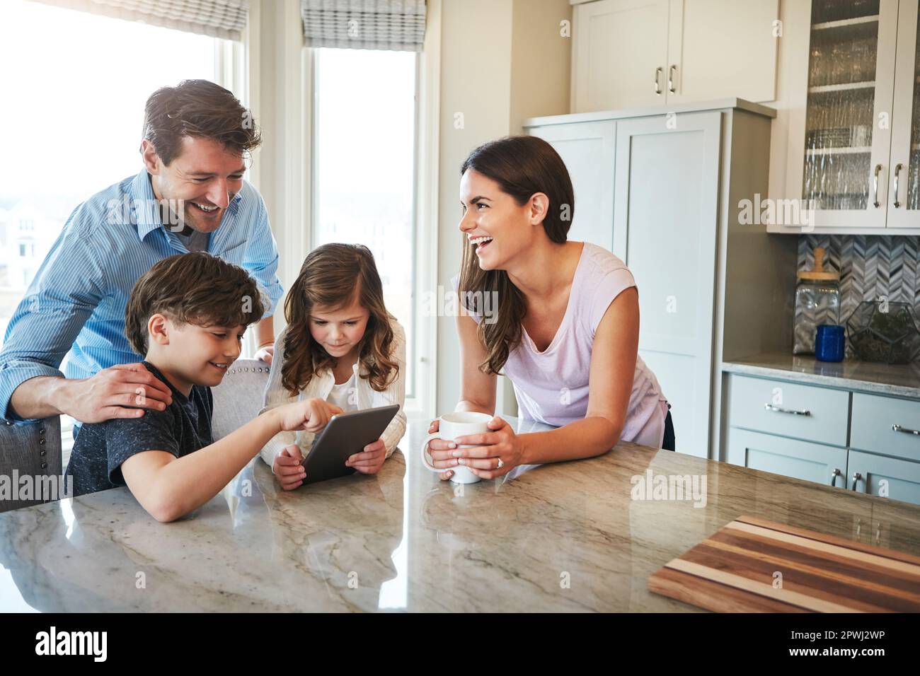 Surfing supervised. a married couple and their young children playing ...